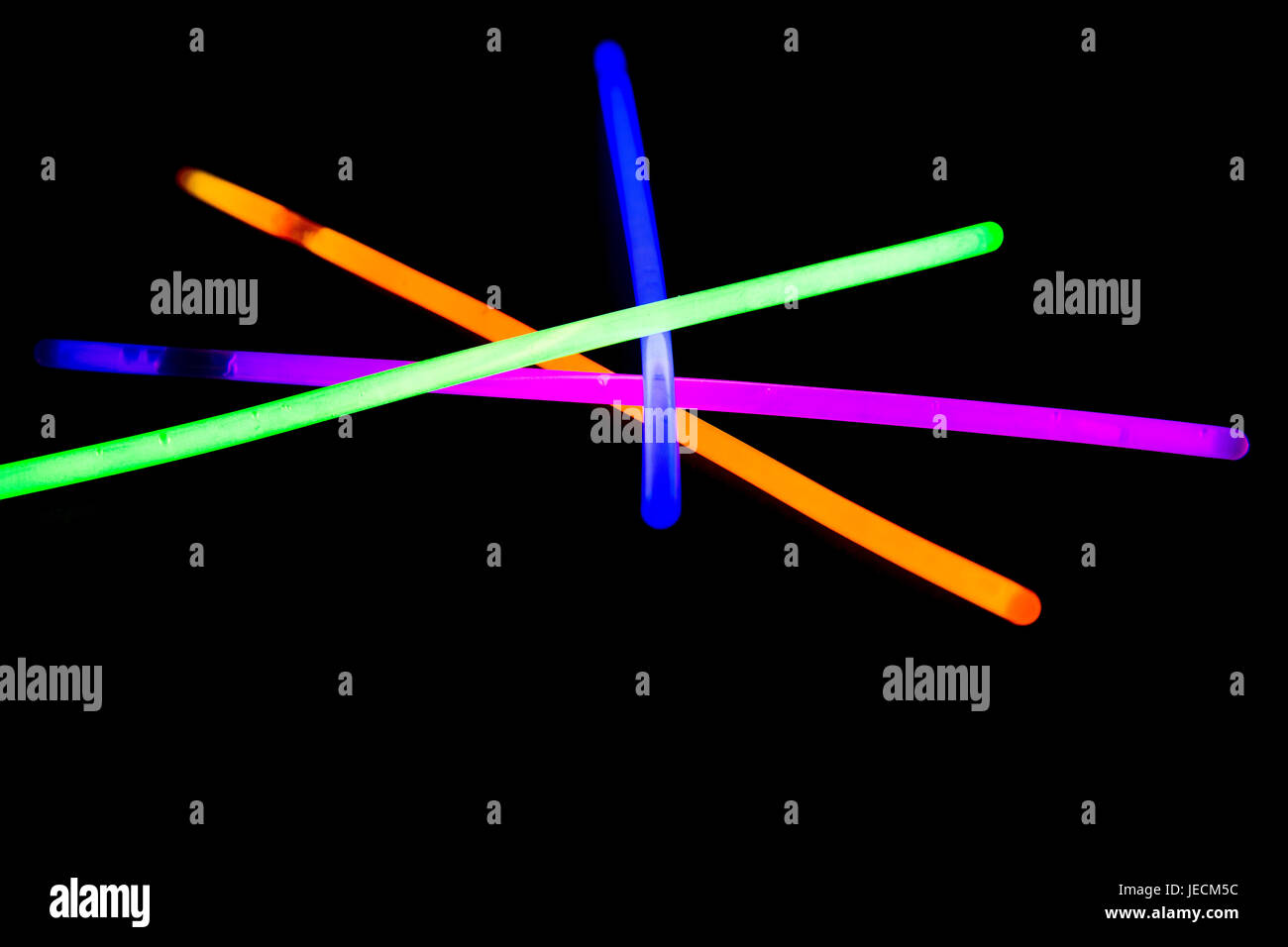 Glow sticks neon light fluorescent on back background. variation of ...