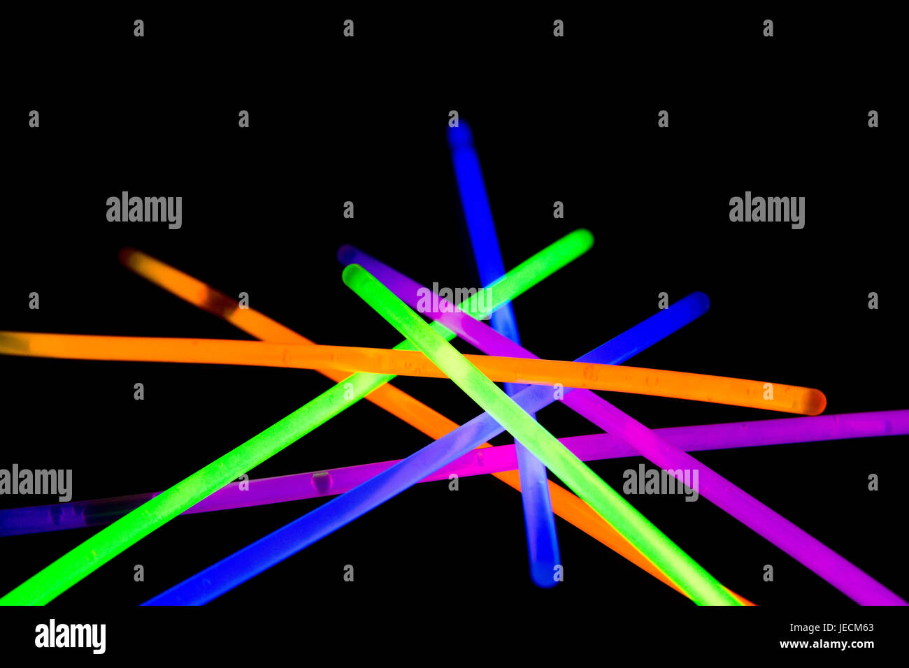 Glow sticks neon light fluorescent on back background. variation of ...