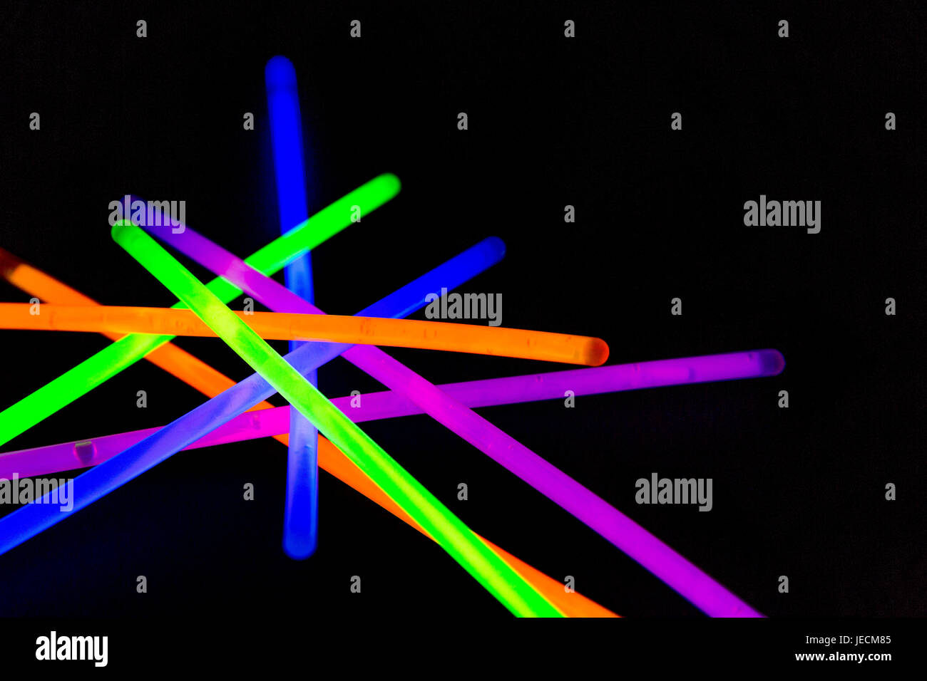 Glow sticks neon light fluorescent on back background. variation of ...