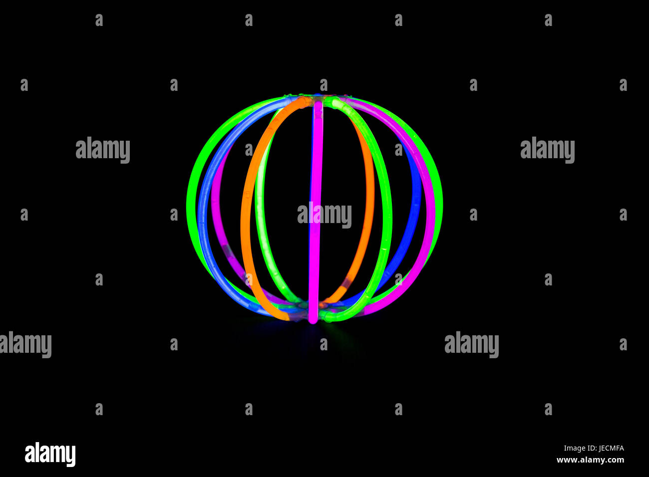 Ball made with glow sticks neon light fluorescent on back background ...