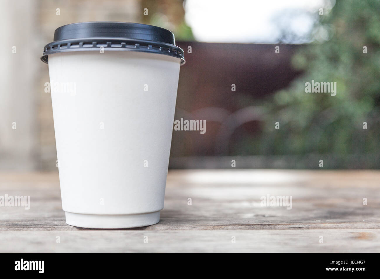 White take away cup with no logo on a table outdoors Stock Photo - Alamy