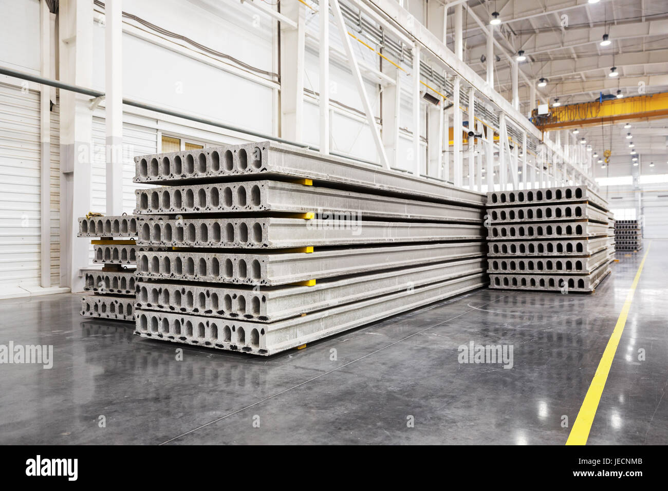 Stack of precast reinforced concrete slabs in a house-building factory ...