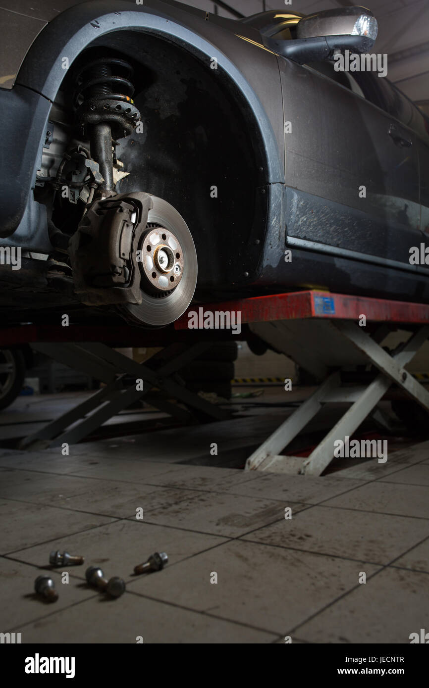 Inside a garage - modern car waiting for the mechanic to change its ...