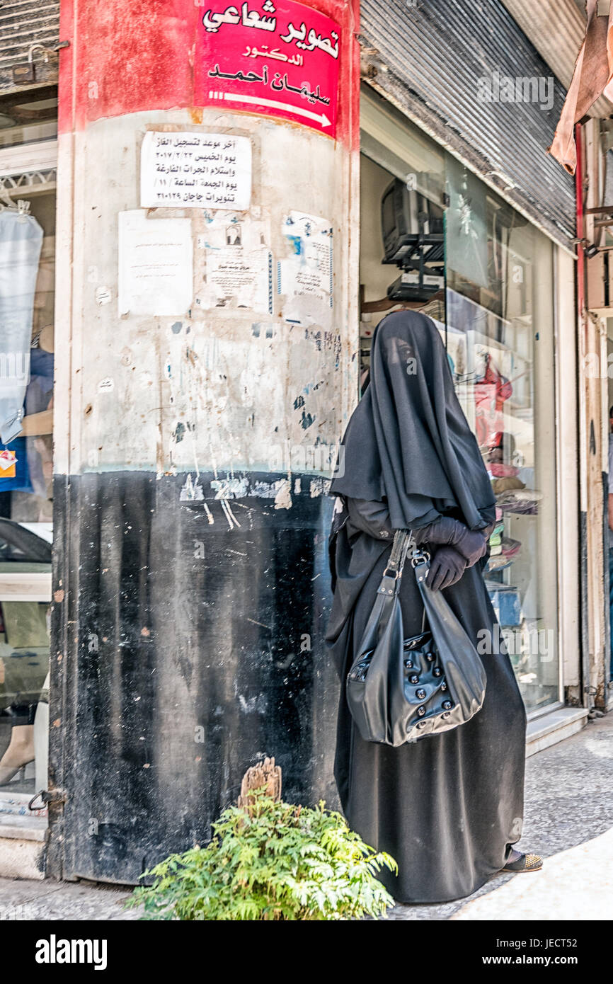 Muslim woman completely covered from head to toe in black veil and ...