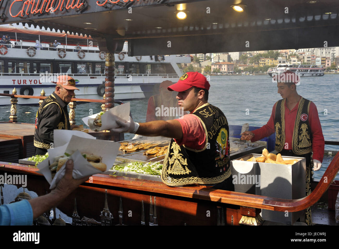 Turkey, Istanbul, fish restaurant on a ship, seller of fish sandwiches ...