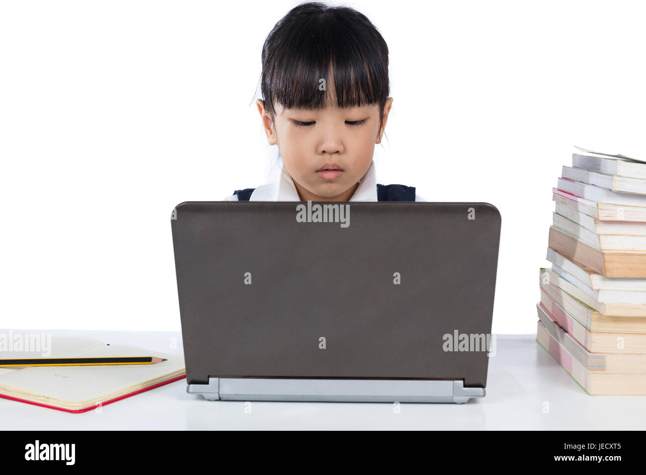 Asian Chinese little girl wearing school uniform study using laptop in ...