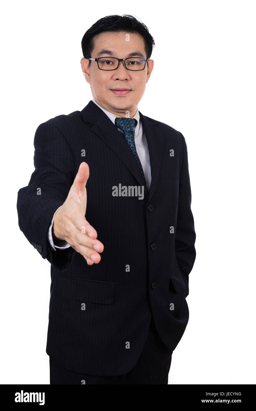 Smiling Asian Chinese man wearing suit posing with handshake gesture in ...