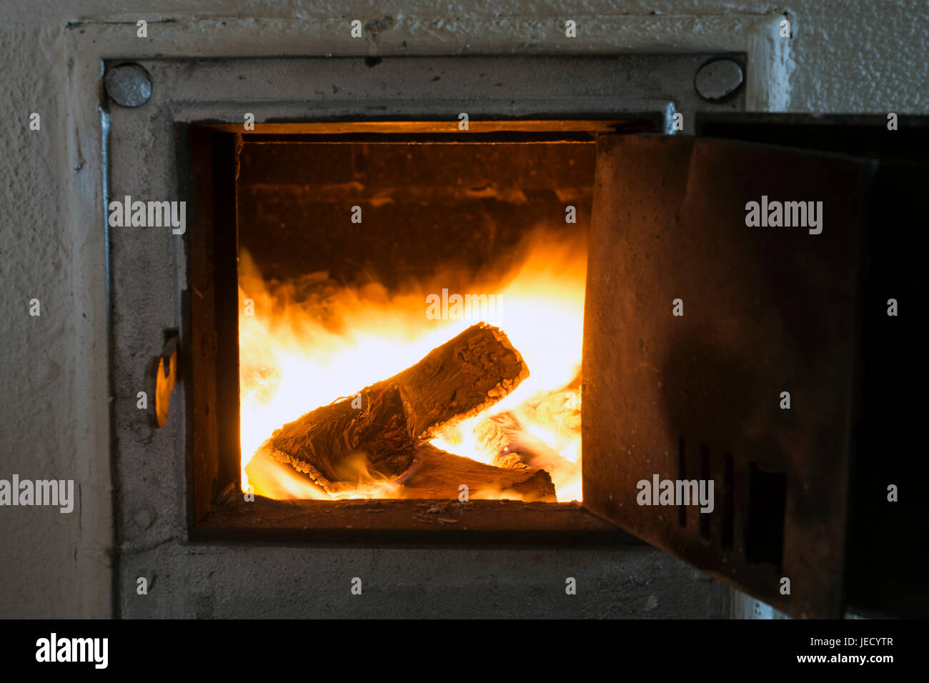 fire inside open furnace with focus on burning log Stock Photo - Alamy