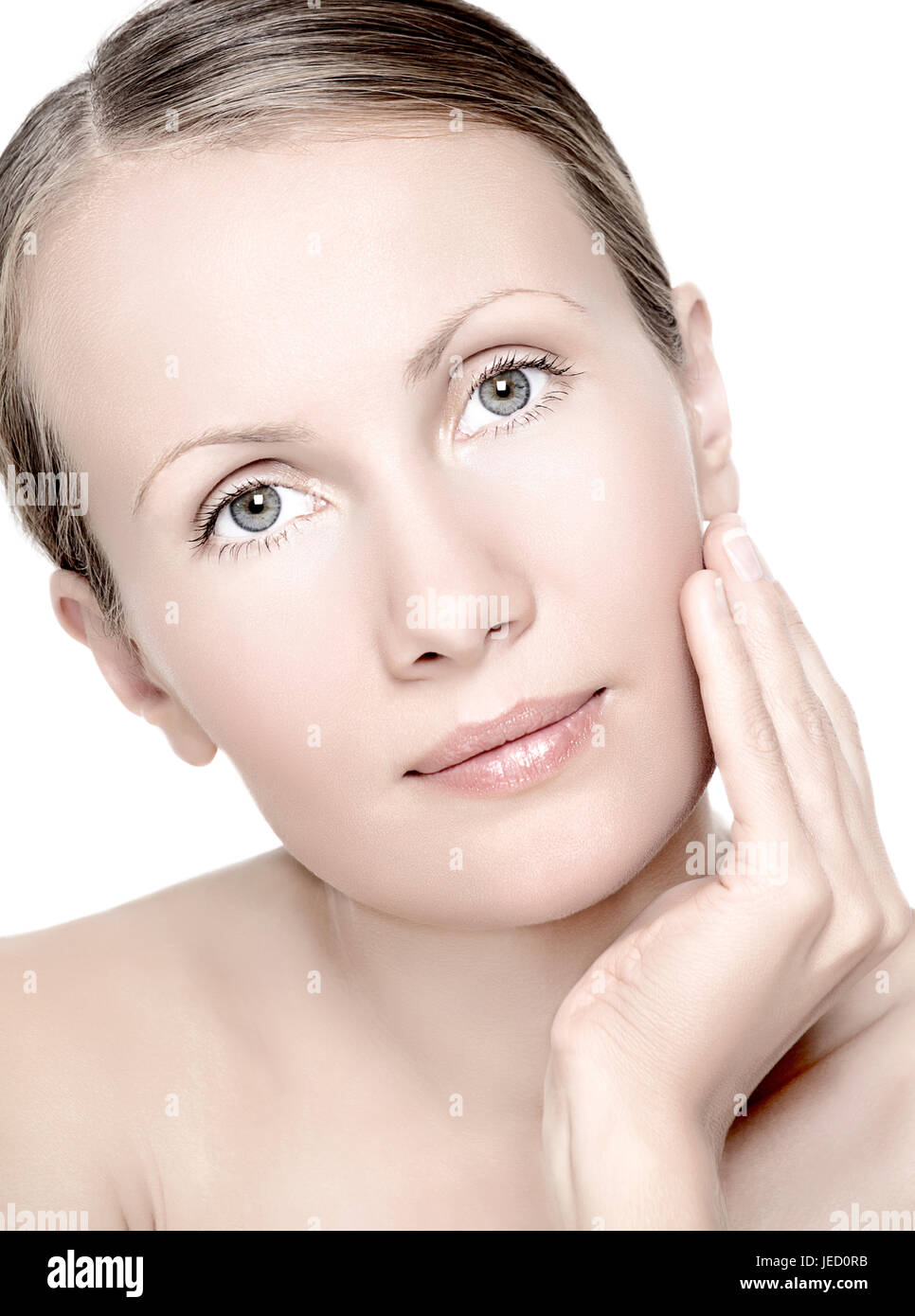 Young woman holding her hand to her face Stock Photo - Alamy