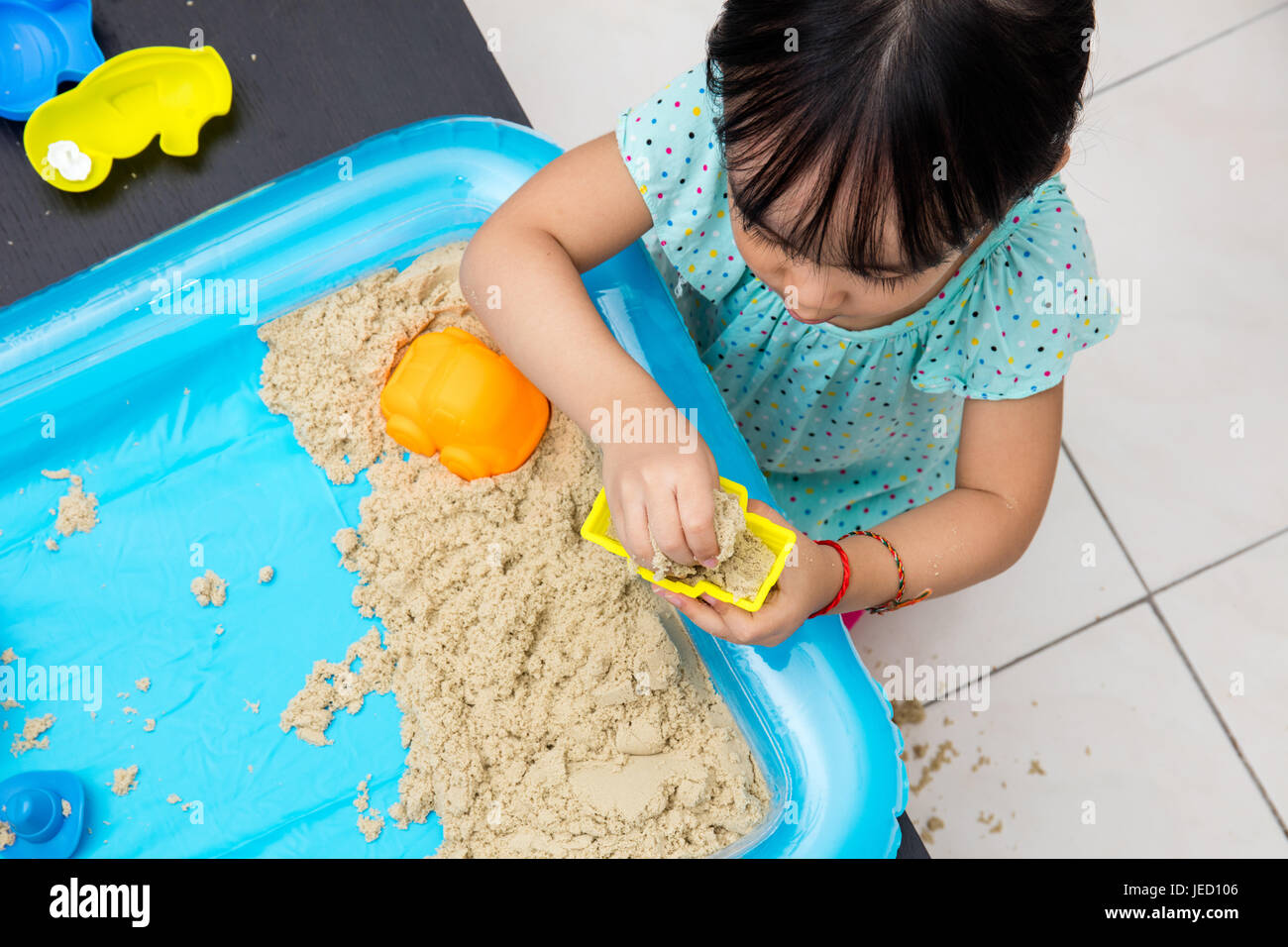 Asian Chinese little girl playing sand in the living room at home Stock ...