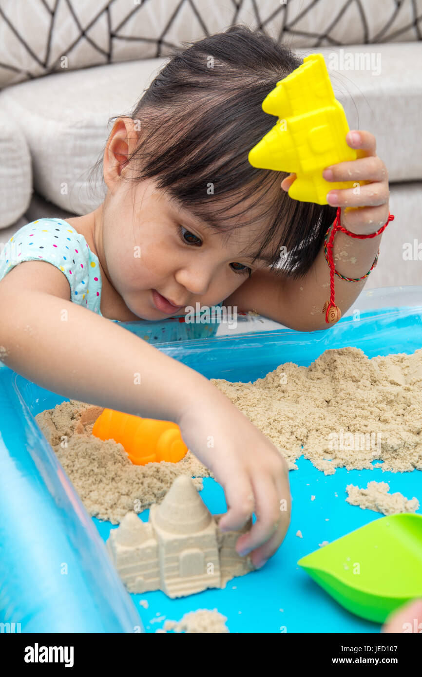 Asian Chinese little girl playing sand in the living room at home Stock ...