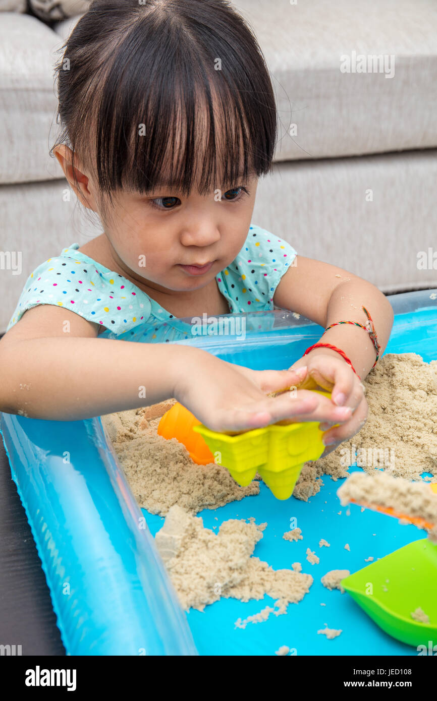 Asian Chinese little girl playing sand in the living room at home Stock ...