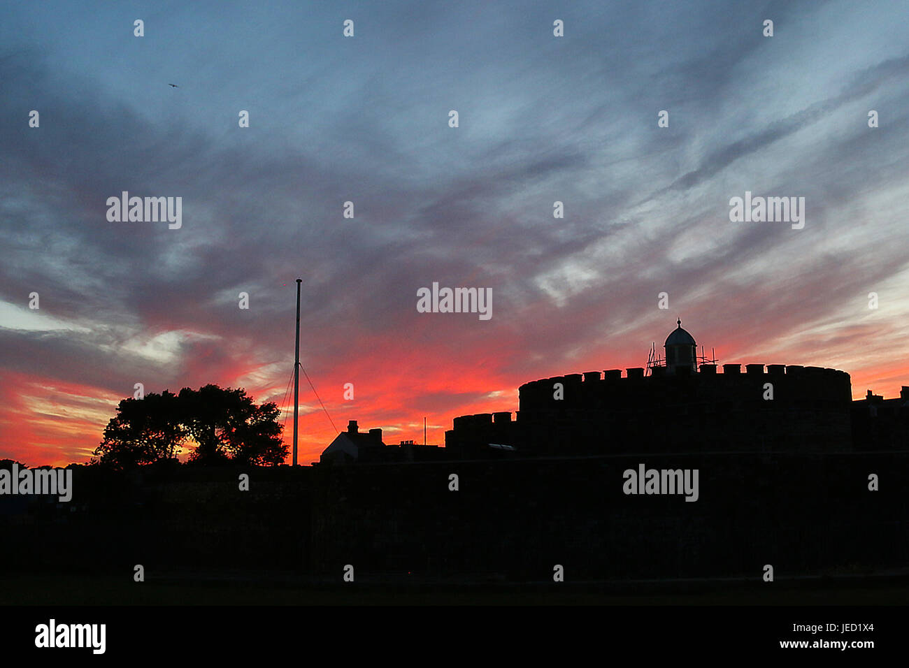 Fiery Sunset over Castle Stock Photo - Alamy