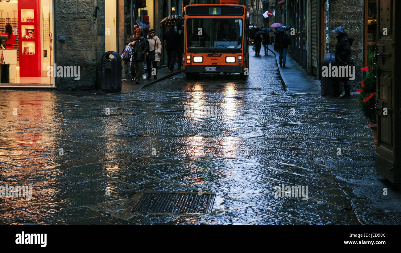 FLORENCE, ITALY - JANUARY 7, 2009: tourists and night bus on street in ...