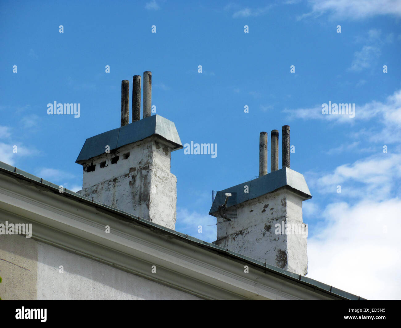 Two chimneys on the roof of the house Stock Photo - Alamy