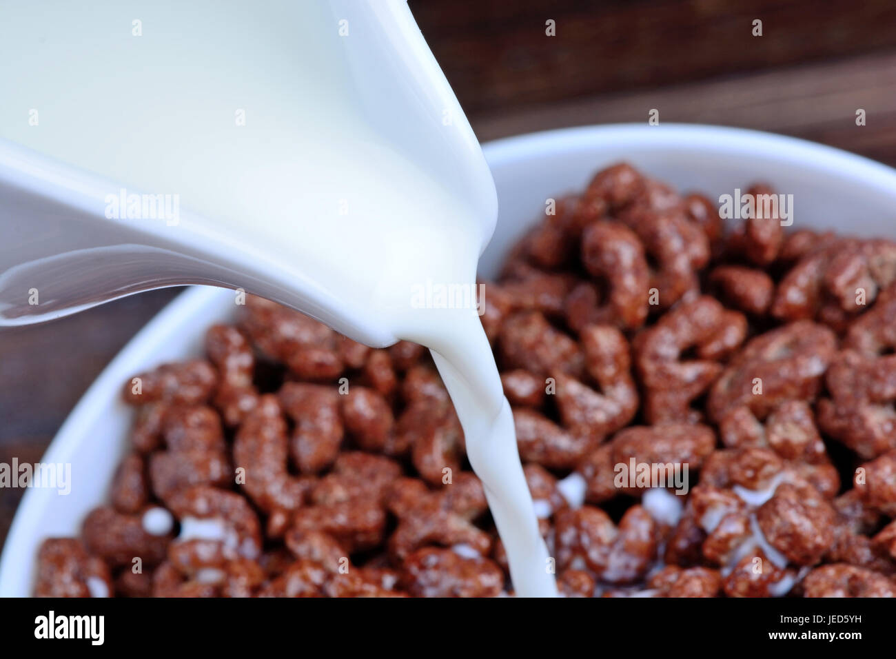 Breakfast with milk pouring cereals in a bowl Stock Photo - Alamy