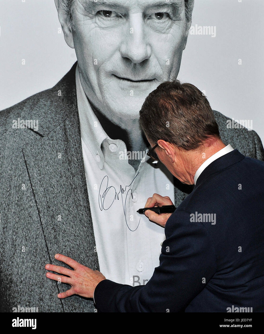 The US American actor Bryan Cranston poses next to his portrait before ...