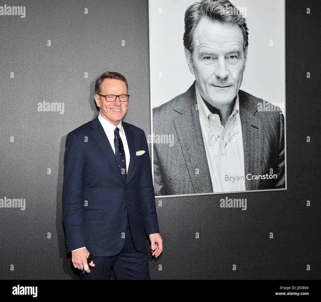The US American actor Bryan Cranston poses next to his portrait before ...