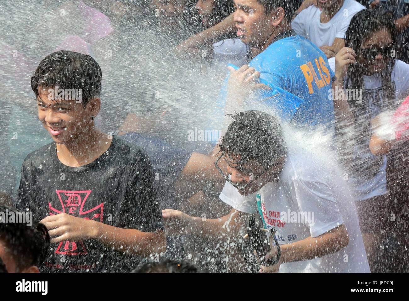 San Juan City, Philippines. 24th June, 2017. Revelers are sprayed with ...