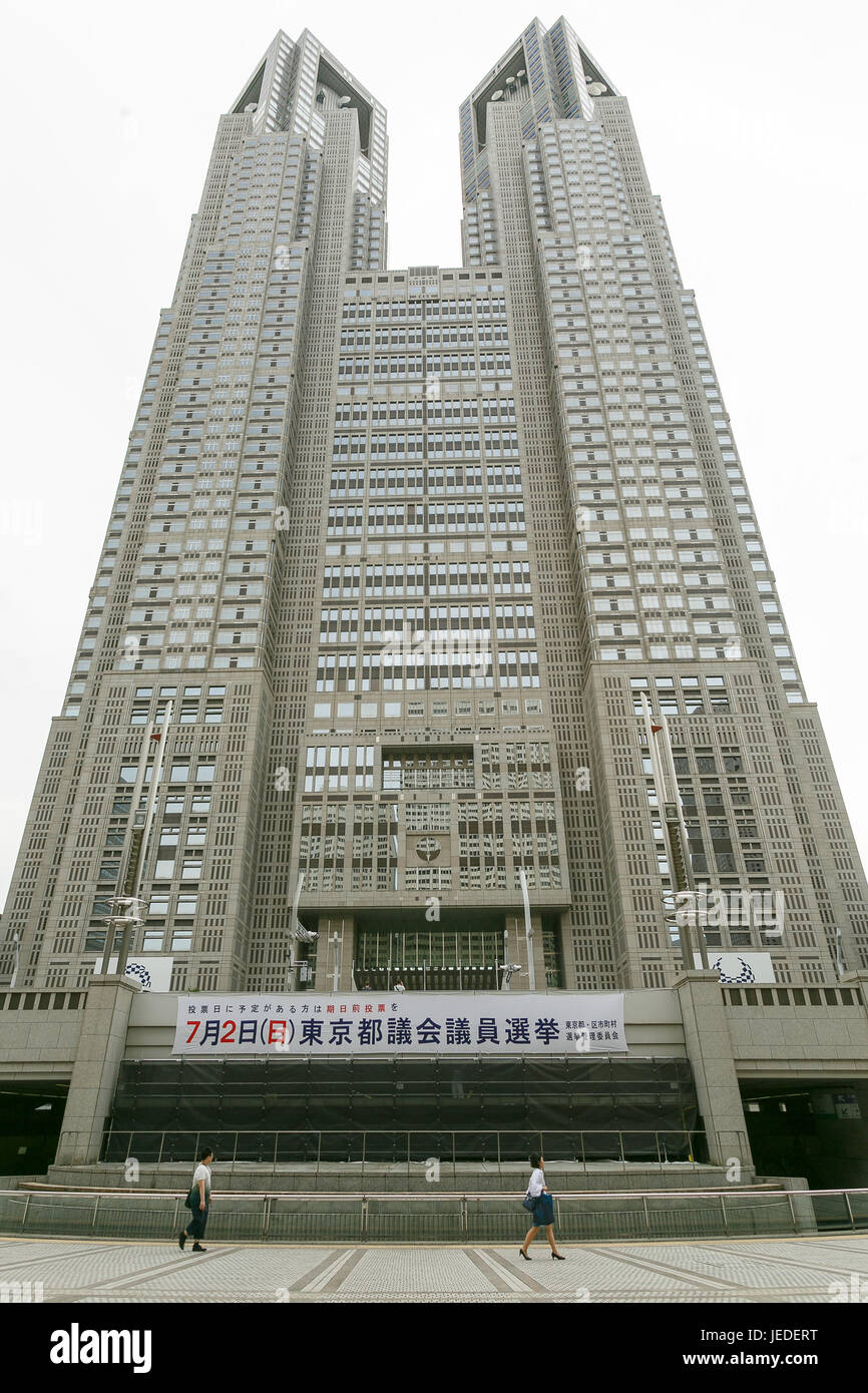 People walk past a huge banner on display at the Tokyo Metropolitan ...