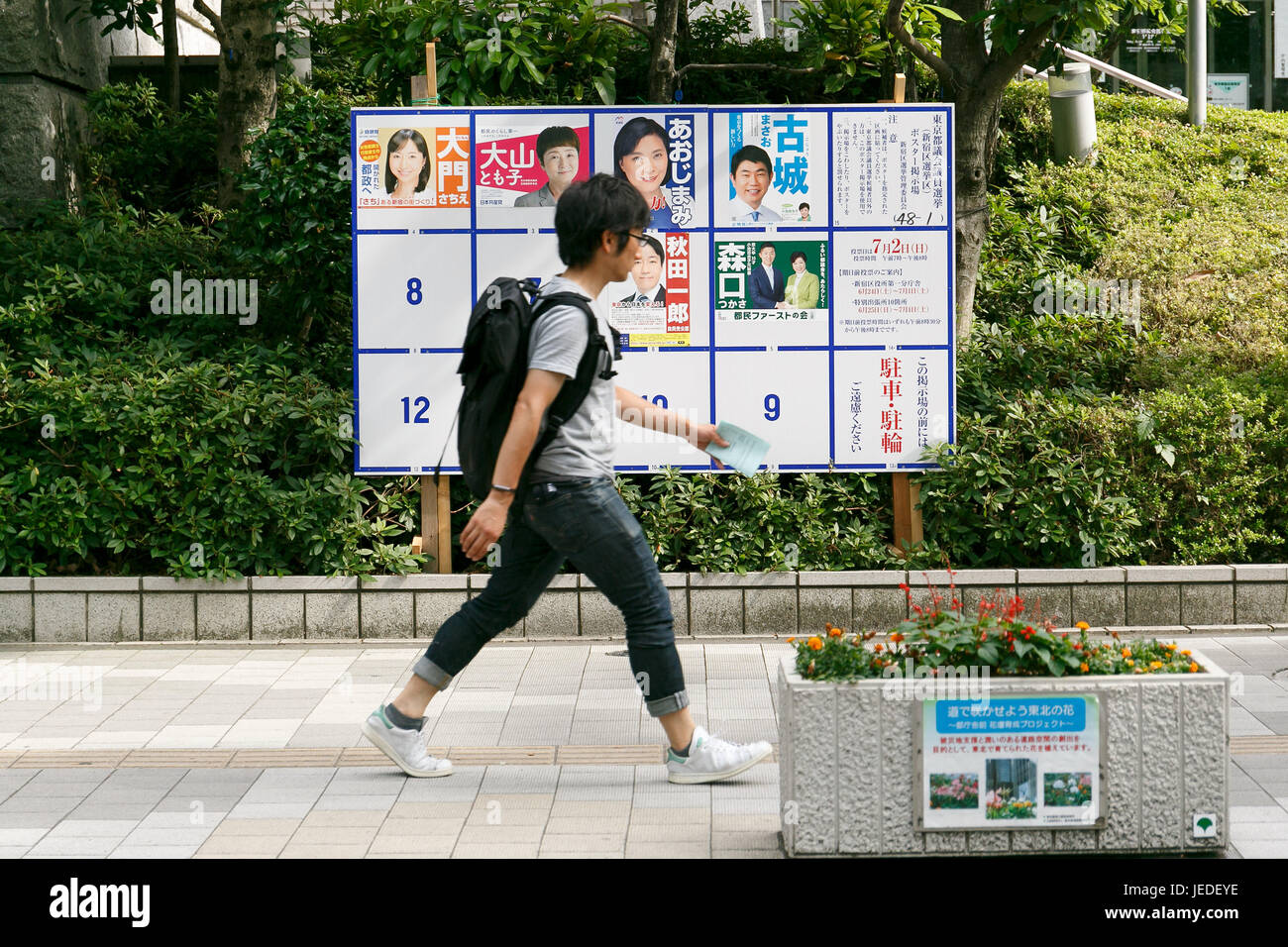 Tokyo, Japan. 24th June, 2017. A man walks past an election poster ...
