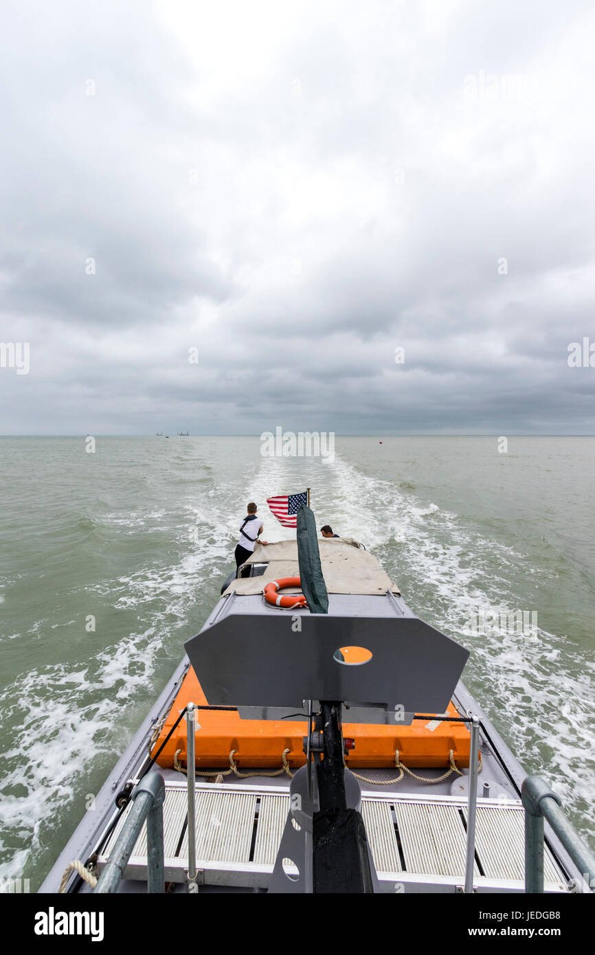 View looking from bridge to stern of boat leaving wake in the sea ...