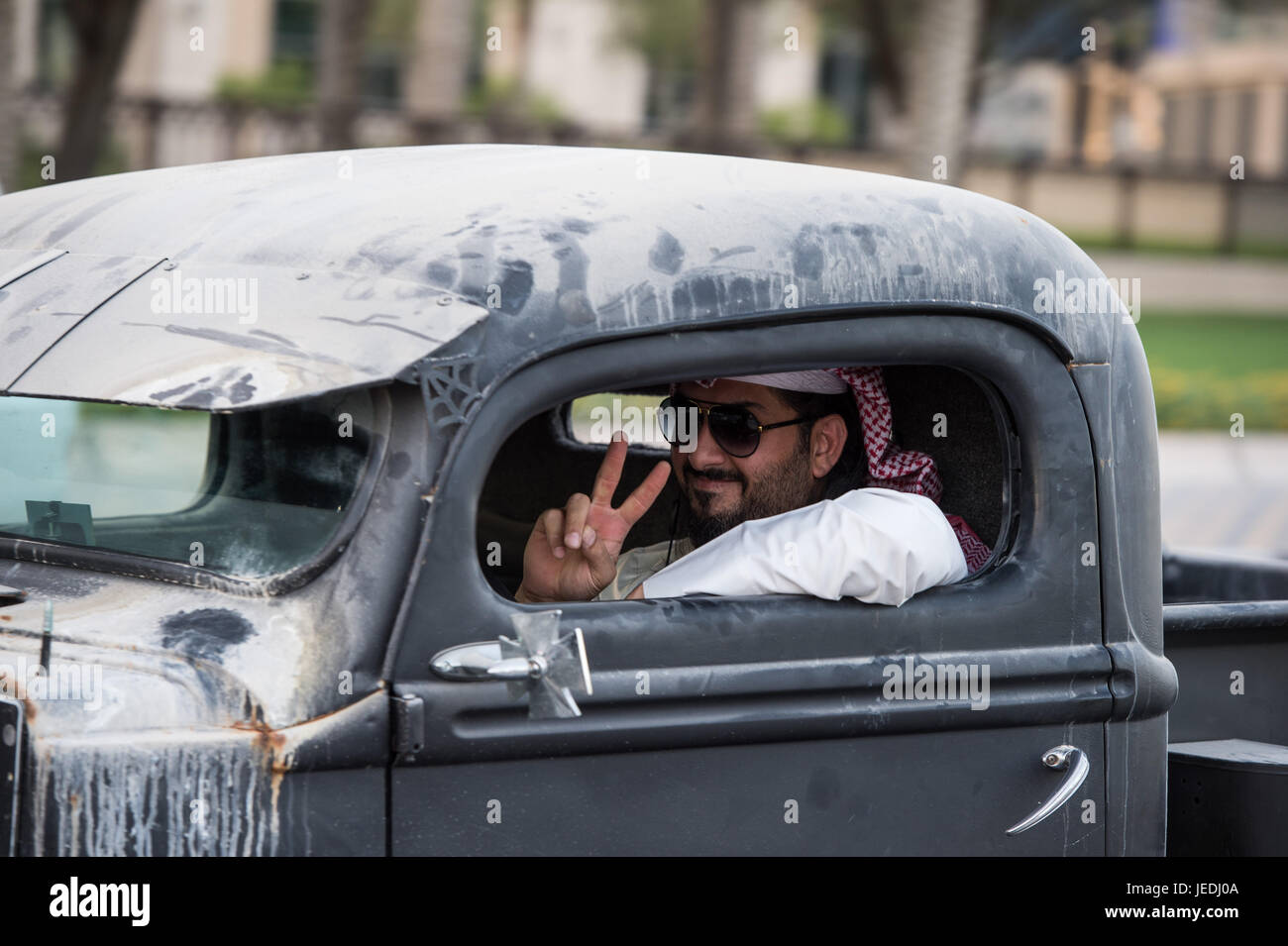 Doha, Qatar. 24th June, 2017. A Qatari man gives a V sign from his ...