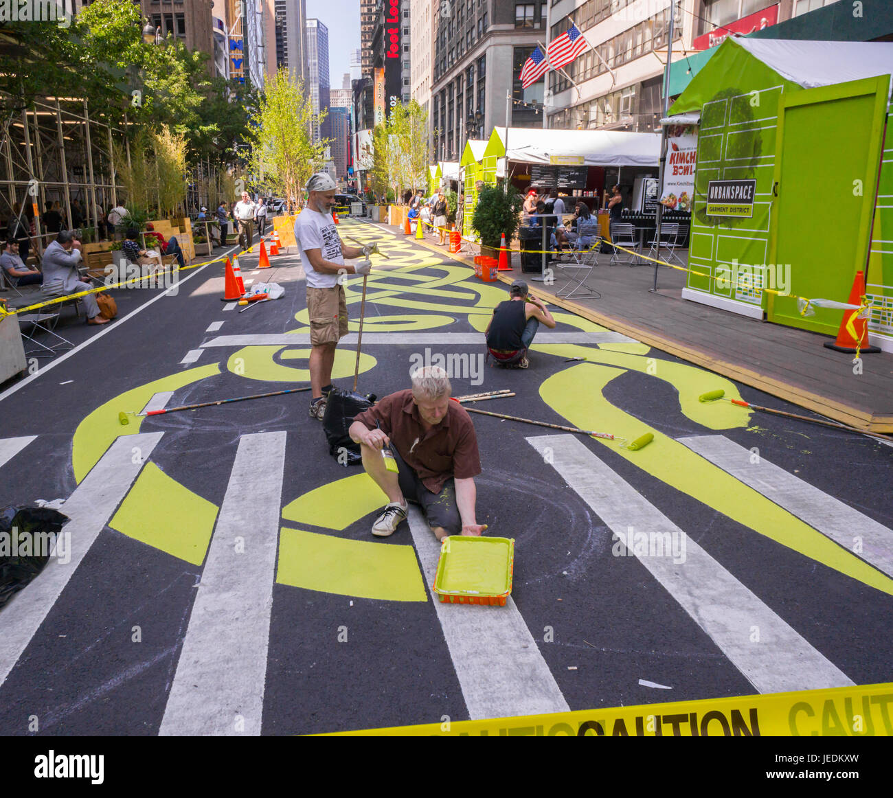 Workers put the finishing touches on a "road tattoo" entitled "sew and ...