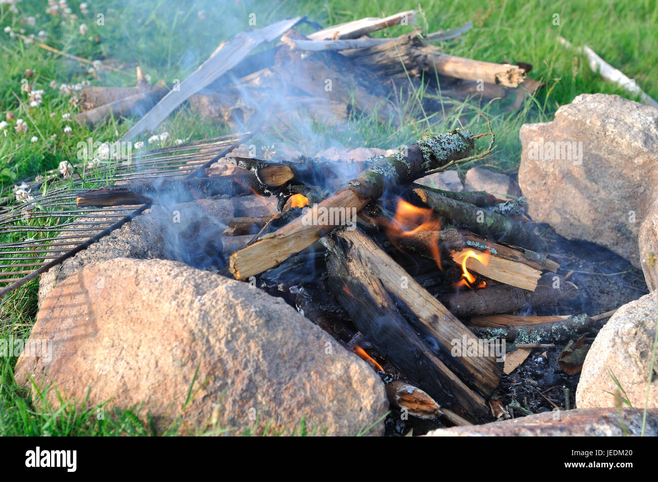 campfire between stones on the grass Stock Photo - Alamy