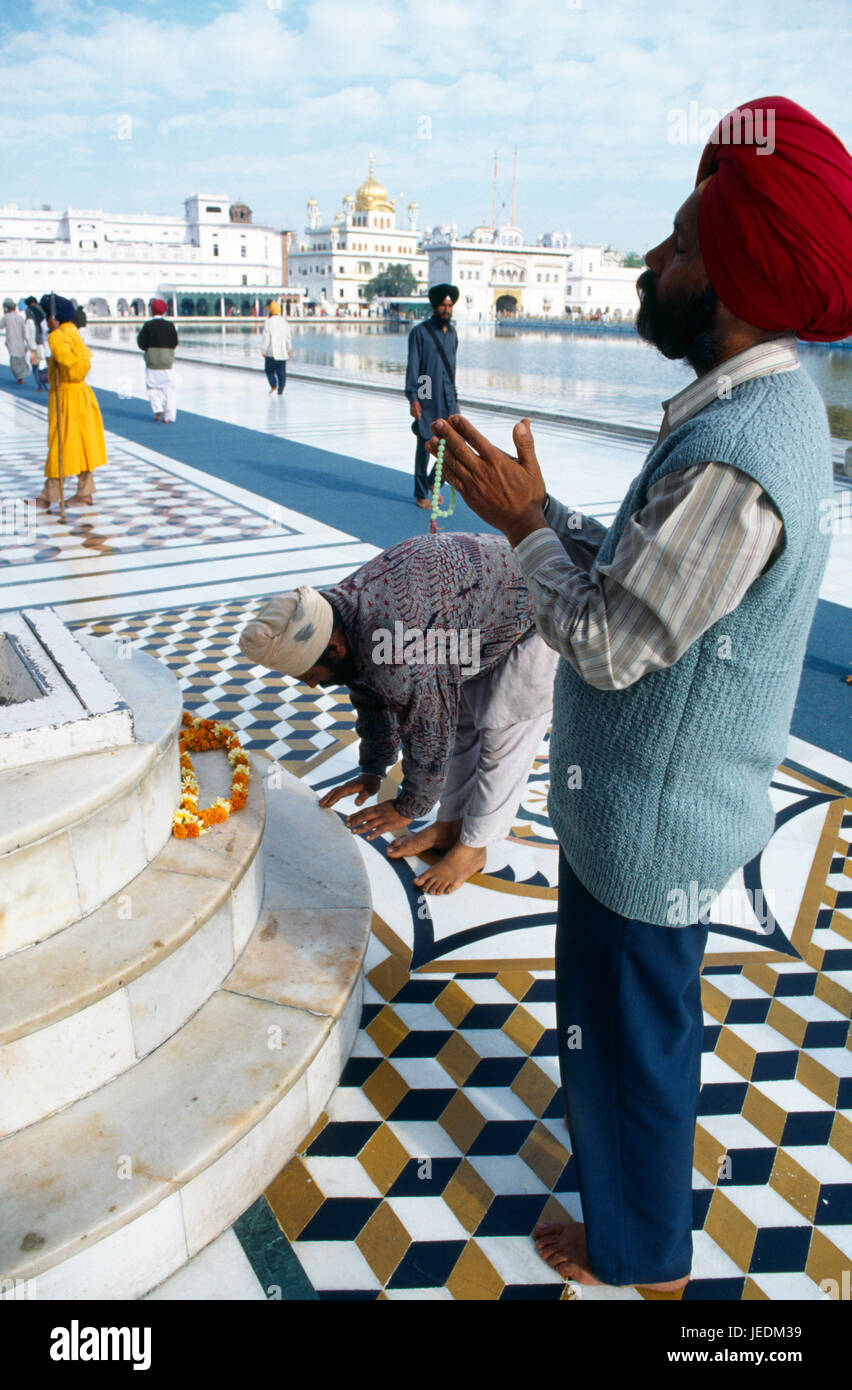 India, Punjab, Amritsar, Barefooted Sikh men praying at shrine in the ...