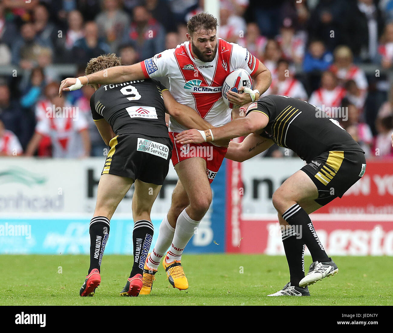 St Helens Alex Walmsley is tackled by Salford Red Devils' Logan Tomkins ...