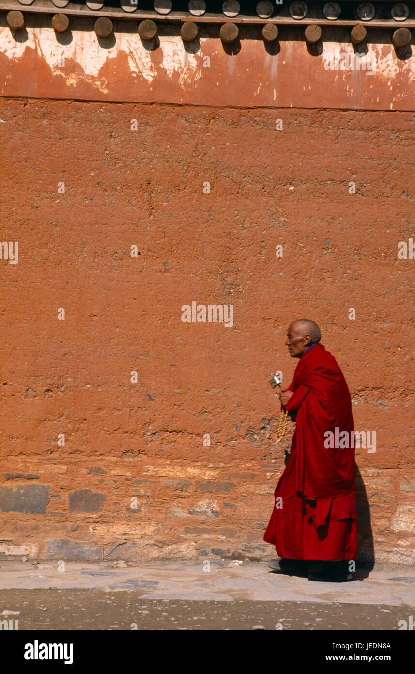 China, Gansu , Xiahe, Labrang Monastery, Monk with prayer beads and ...