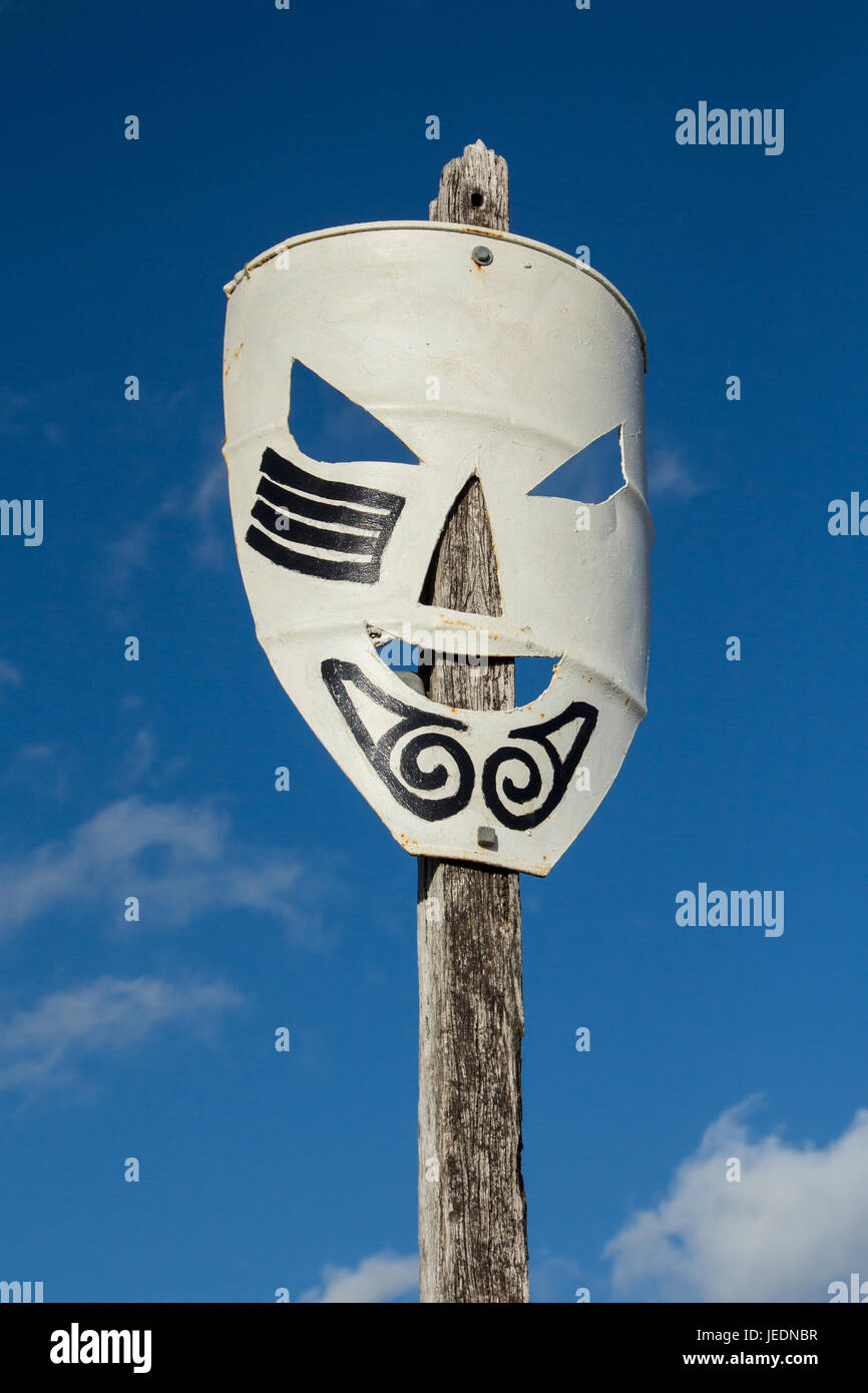 White tin mask on a pole with a bit of maori marking on it Stock Photo ...