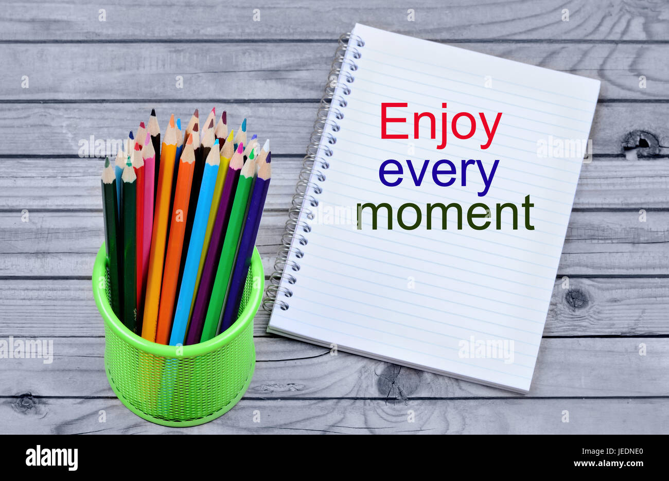 Enjoy every moment words on notebook page Stock Photo - Alamy