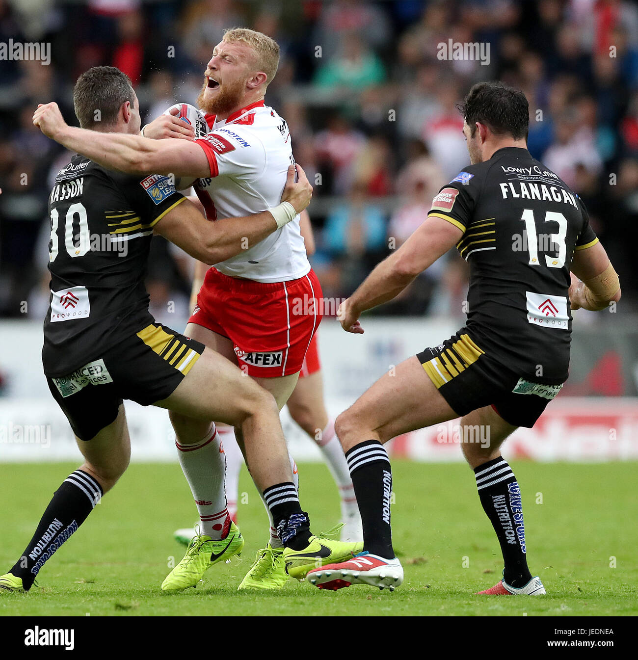 St Helens Luke Thompson is tackled by Salford Red Devils' James Hasson ...