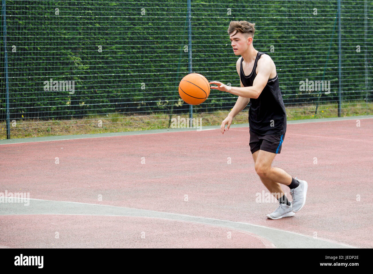 Boy bouncing basketball hi-res stock photography and images - Alamy