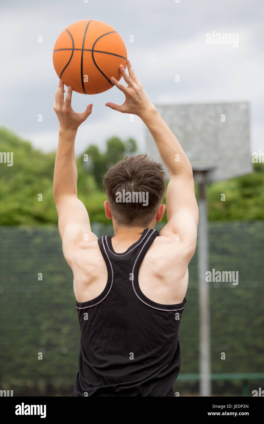 Male Teen Shooting Basketball High Resolution Stock Photography and ...