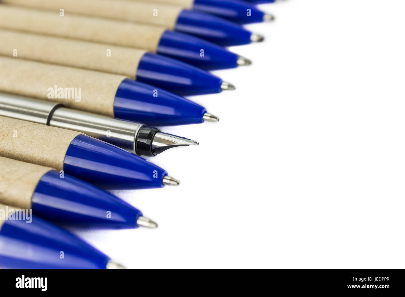 closeup of a silver fountain pen surrounded by cheap pens and ordinary ...