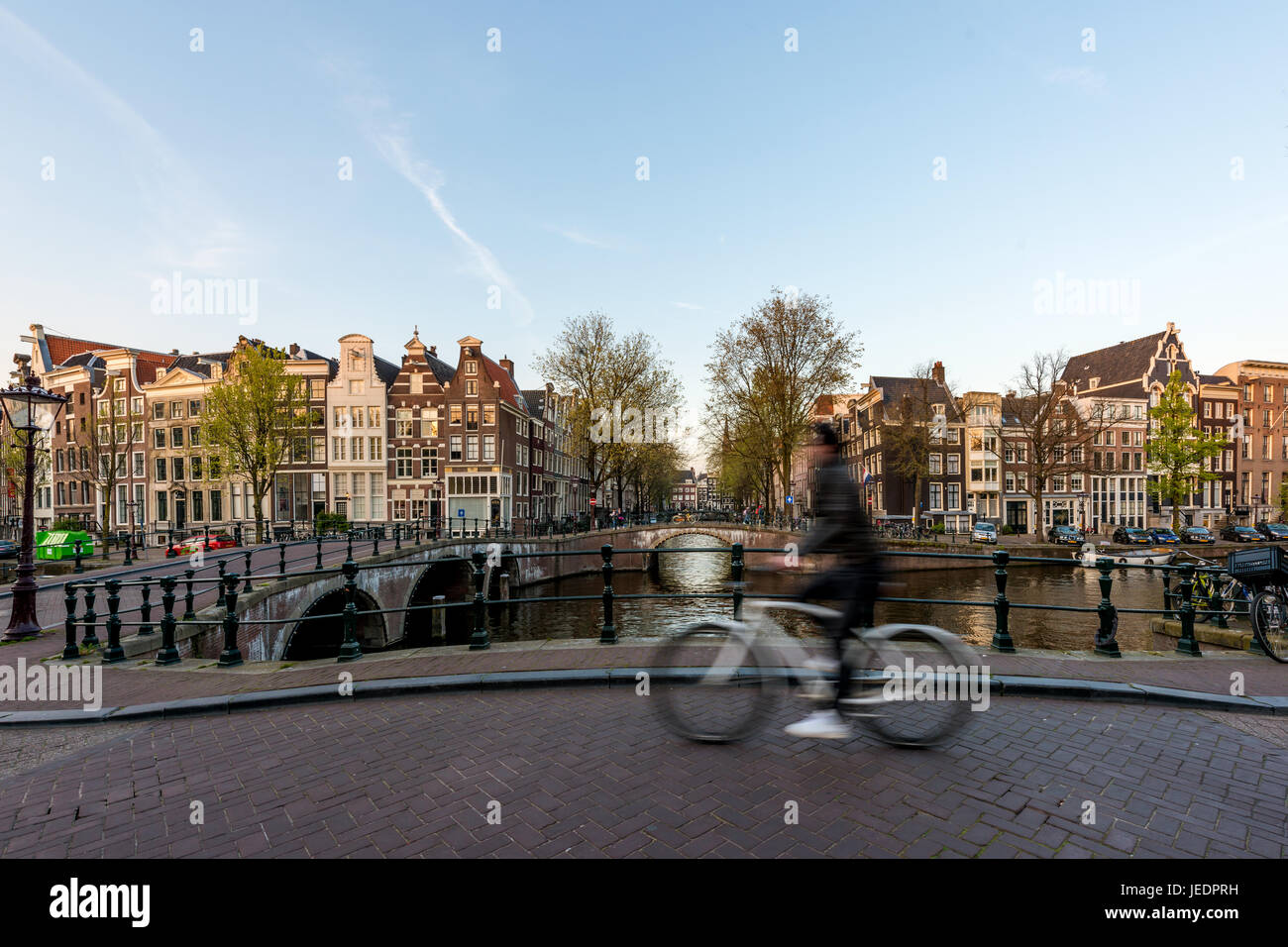 Amsterdam people riding bicycles in historical part in Amsterdam ...
