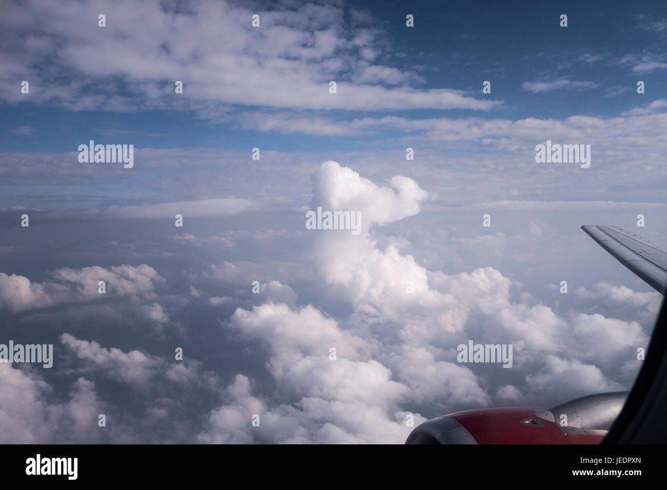 above the clouds flying high on airplane window view Stock Photo - Alamy