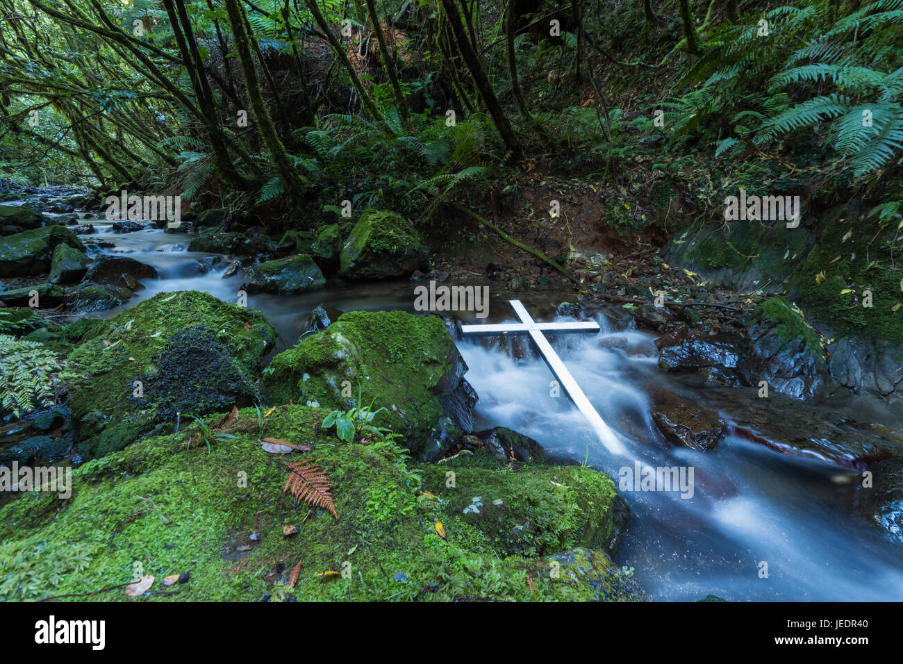 Cross in a stream of soft flowing water Stock Photo - Alamy