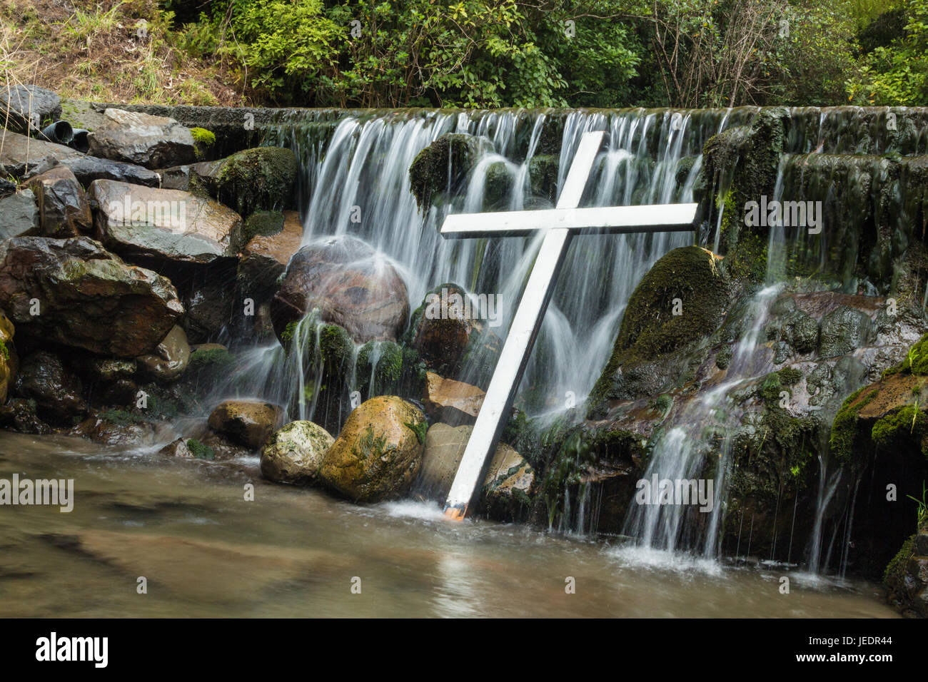 Water falling down over a white cross Stock Photo - Alamy