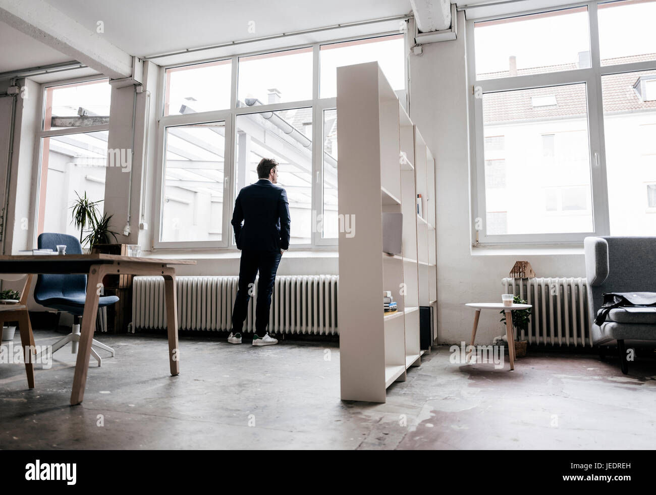 Businessman standing at the window Stock Photo - Alamy