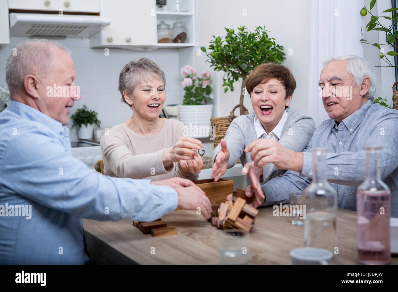 Group of seniors having a games evening at home Stock Photo - Alamy