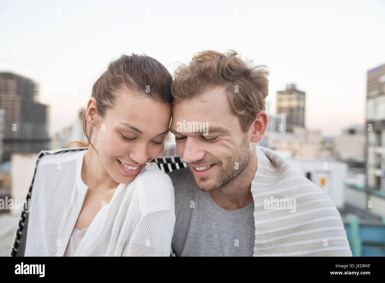 Romantic couple sitting on rooftop terrace, enjoying the view Stock ...