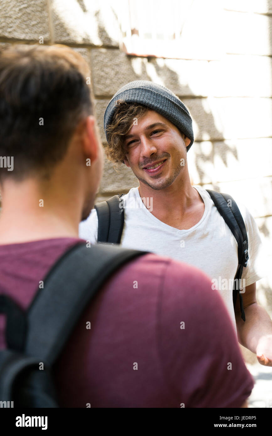 Two young men talking in the city Stock Photo - Alamy