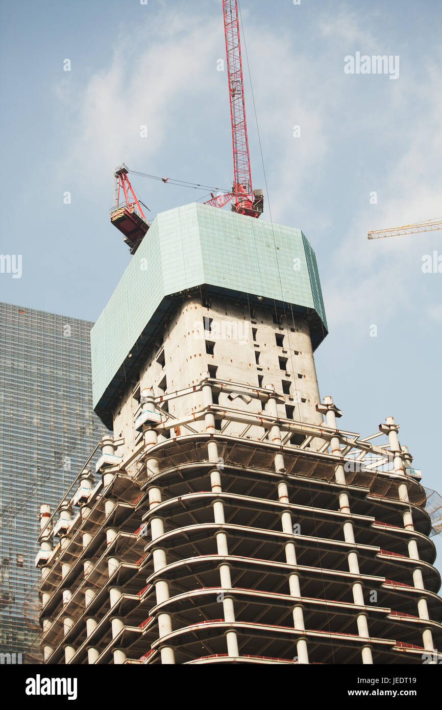Building site - skyscraper making; Crane at the top of the building ...