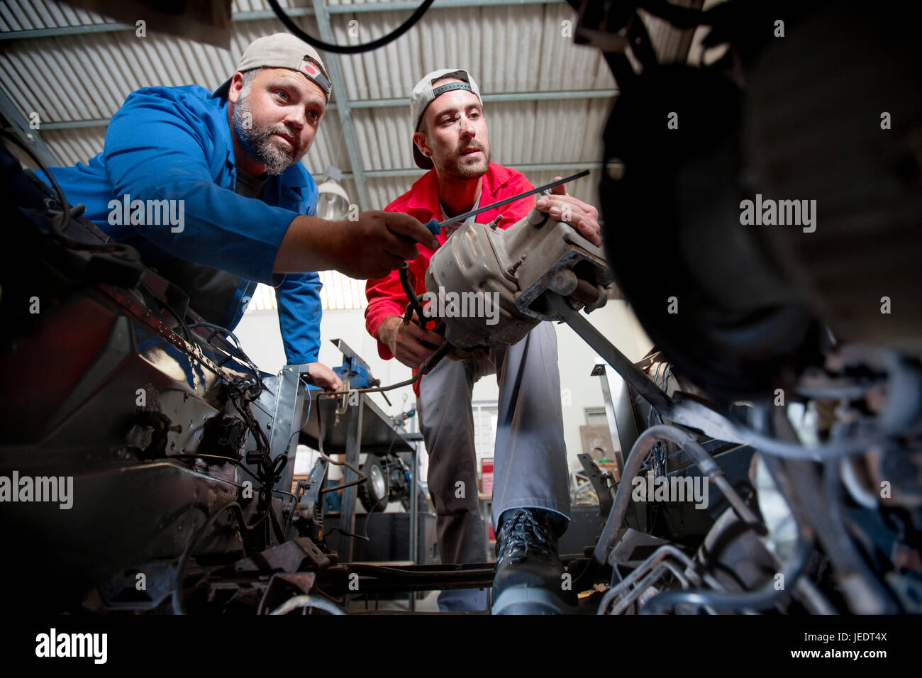 Mechanics in garage workshop discussing hi-res stock photography and ...