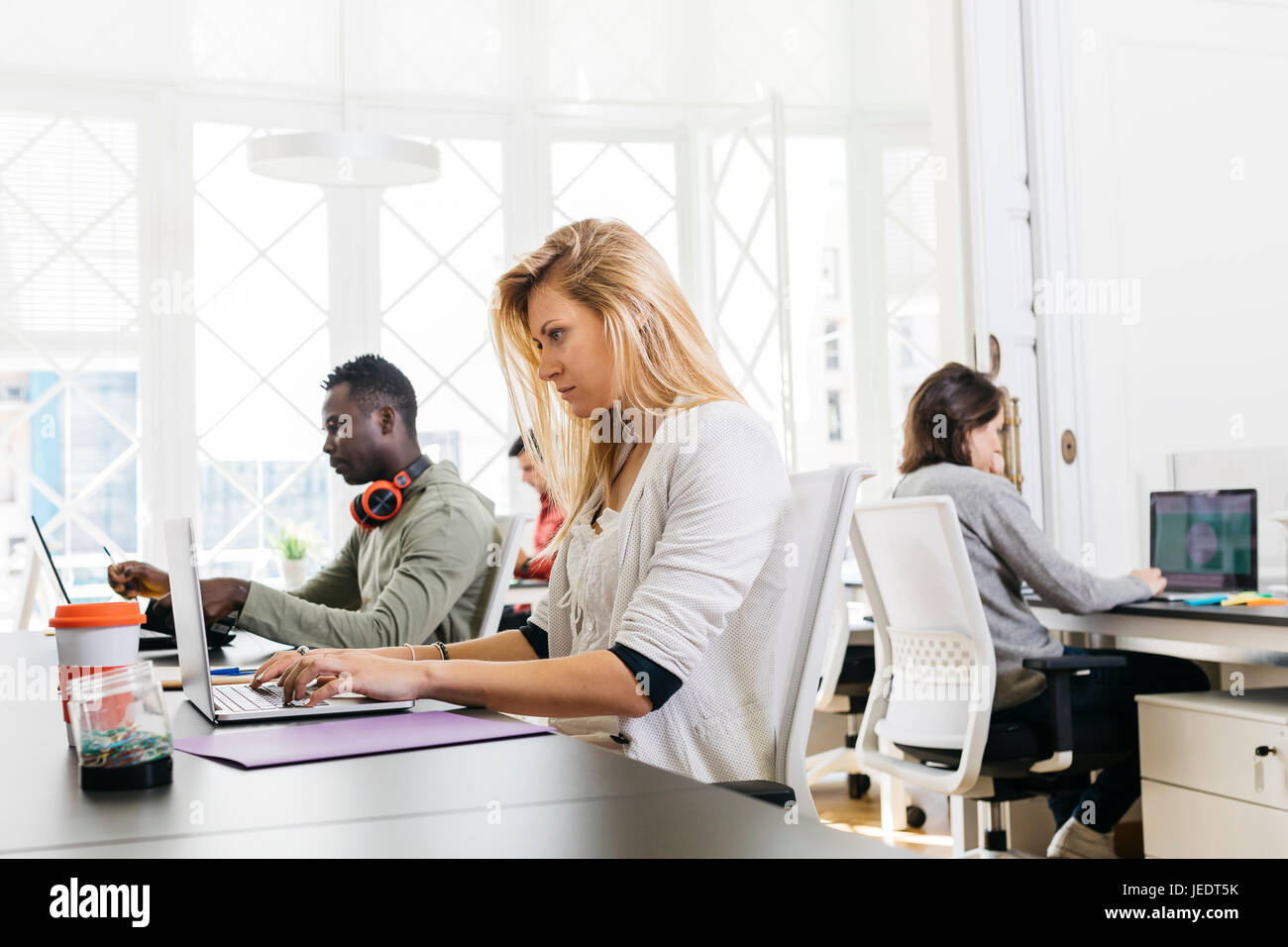 Business people working together in international office Stock Photo ...