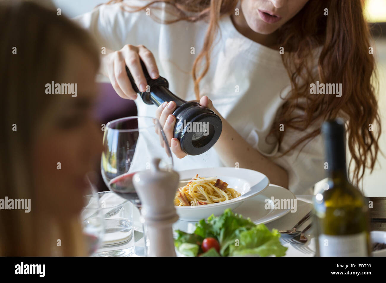 Friends eating together spaghetti carbonara Stock Photo - Alamy